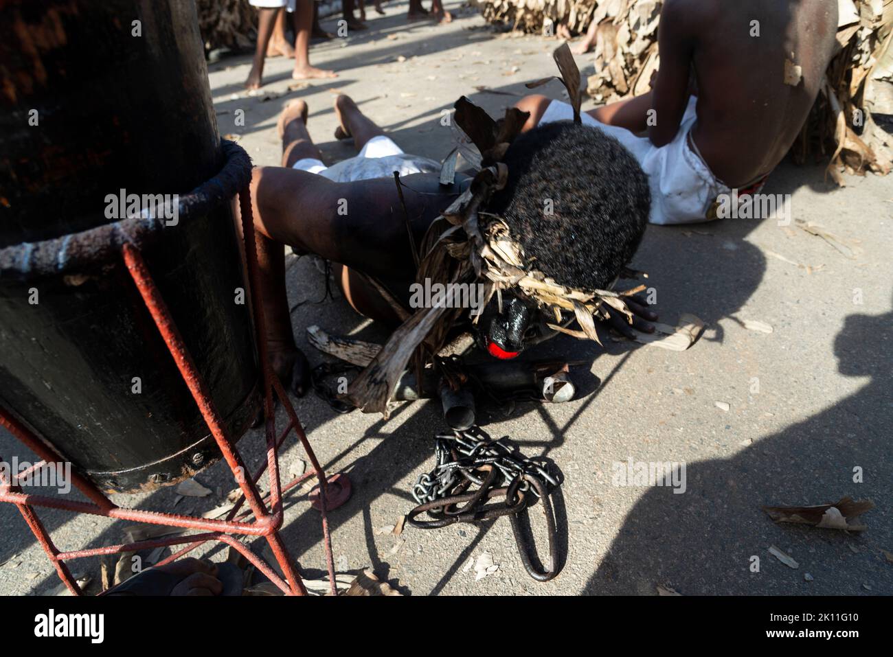 Members of the cultural event Nego Fugido sing and sit on the ground ...