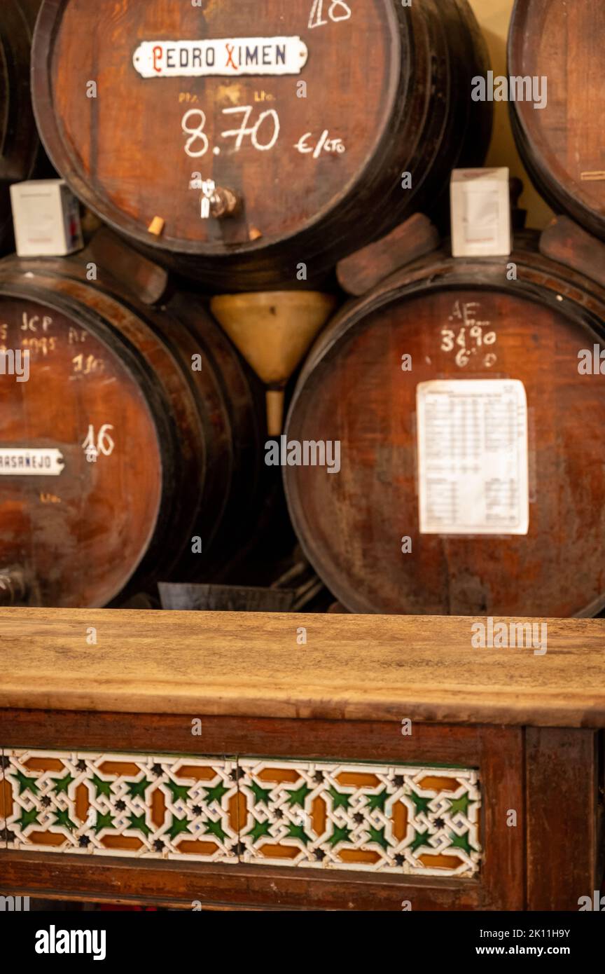 Tasting of different sweet wines from wooden barrels on old bodega wine ...