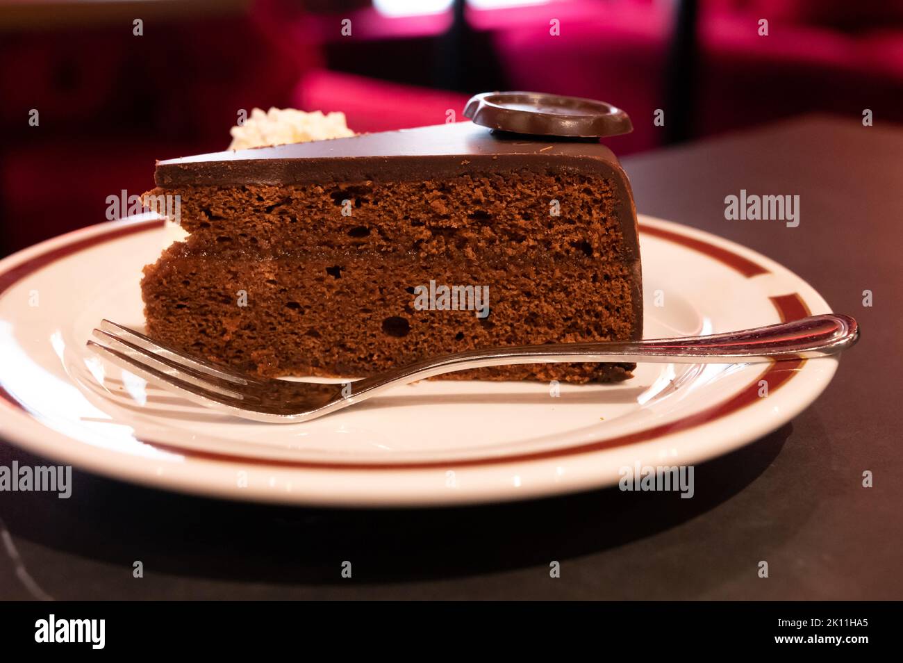 Piece of famous Sachertorte chocolate cake with apricot jam of Austrian ...