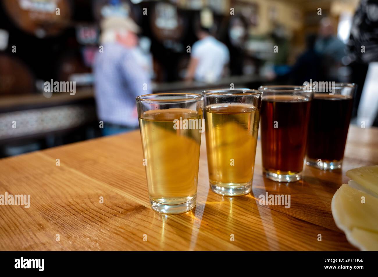 Tasting of different sweet wines from wooden barrels on old bodega wine ...
