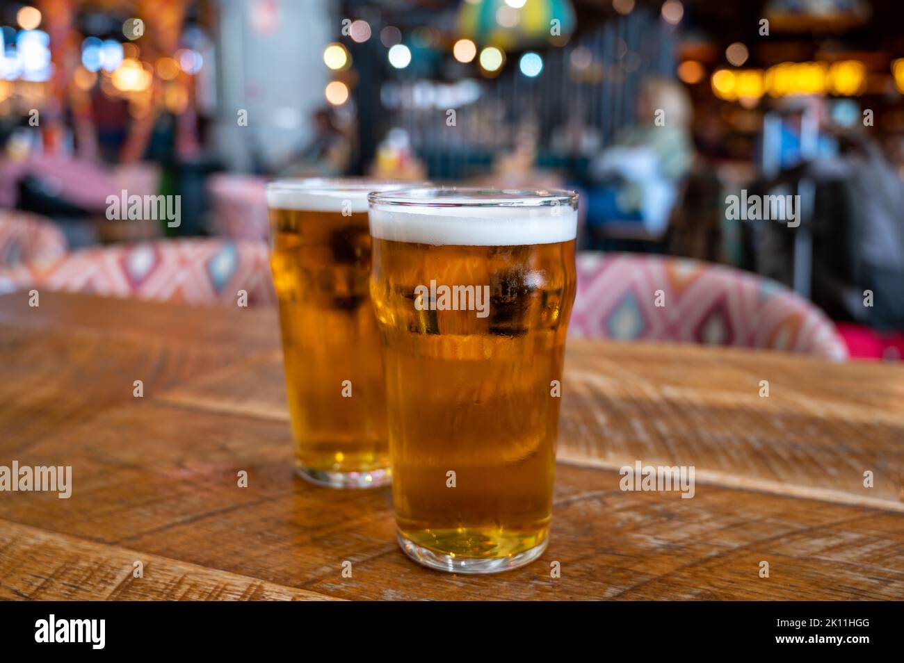 Fresh draught lager beer is glass served in indoor cafe close up Stock ...