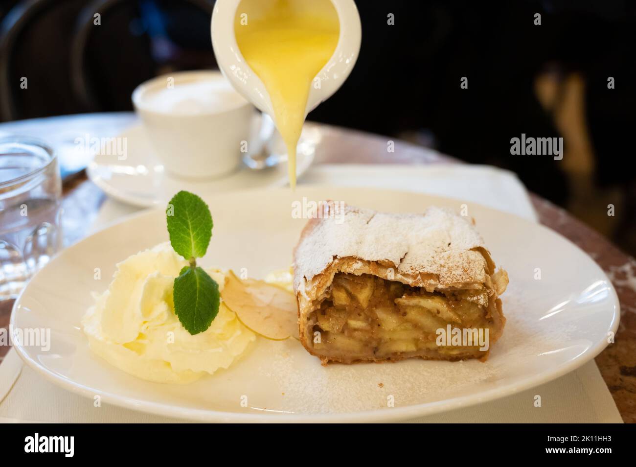 Austrian sweet dessert, portion of apple strudel with whippen cream and ...