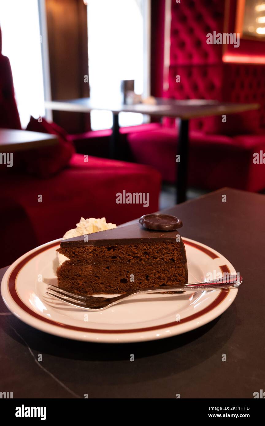 Piece of famous Sachertorte chocolate cake with apricot jam of Austrian ...