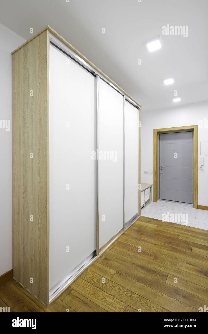 White sliding wardrobe in the hallway Stock Photo - Alamy