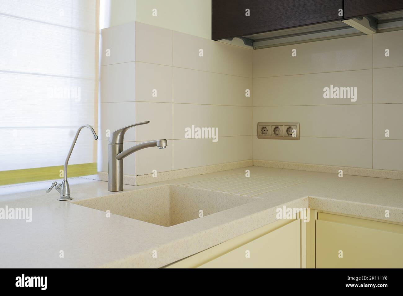 Faucet and sink in the kitchen interior Stock Photo - Alamy