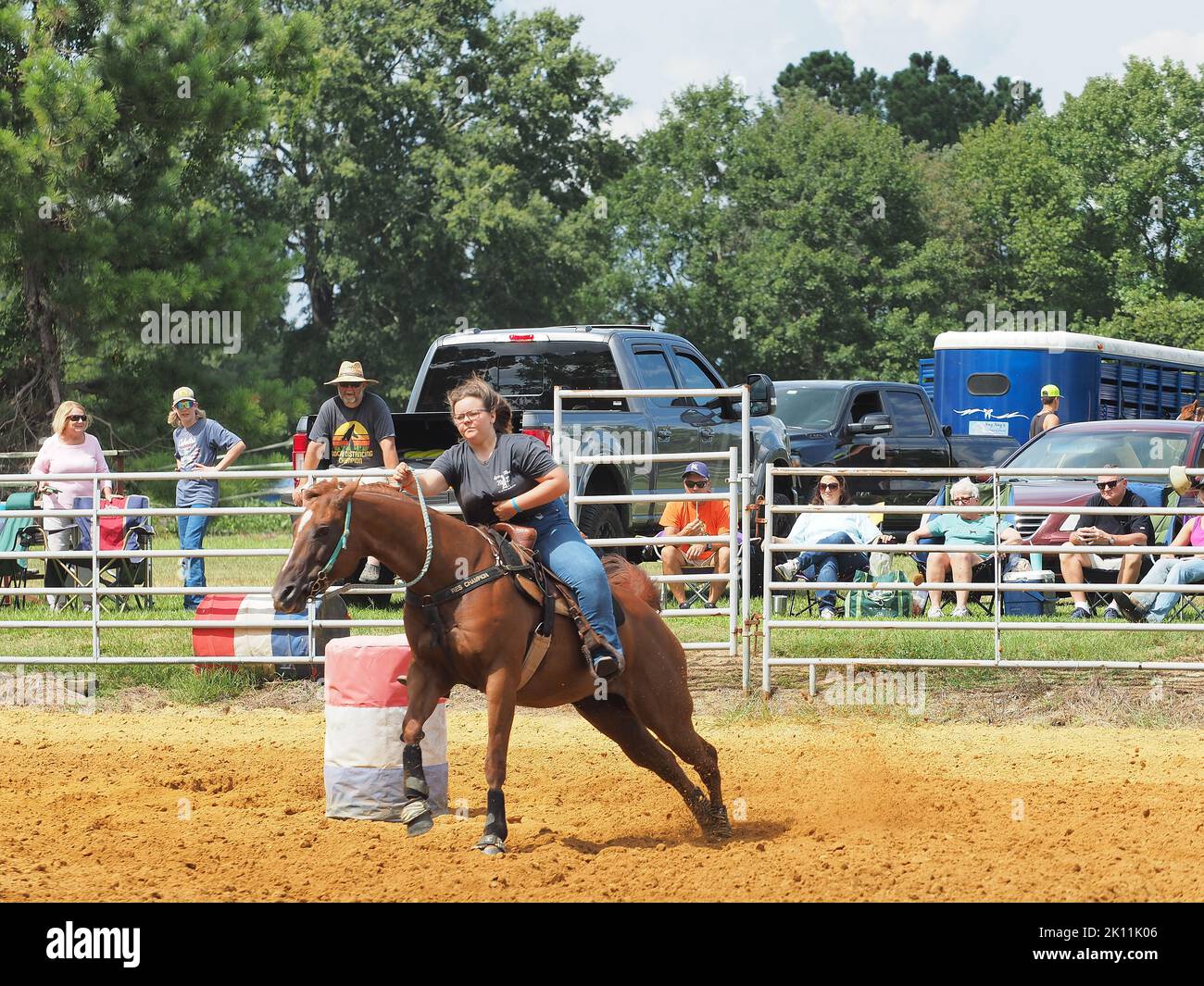 Young female Barrel racing riding a brown quarter horse Stock Photo - Alamy
