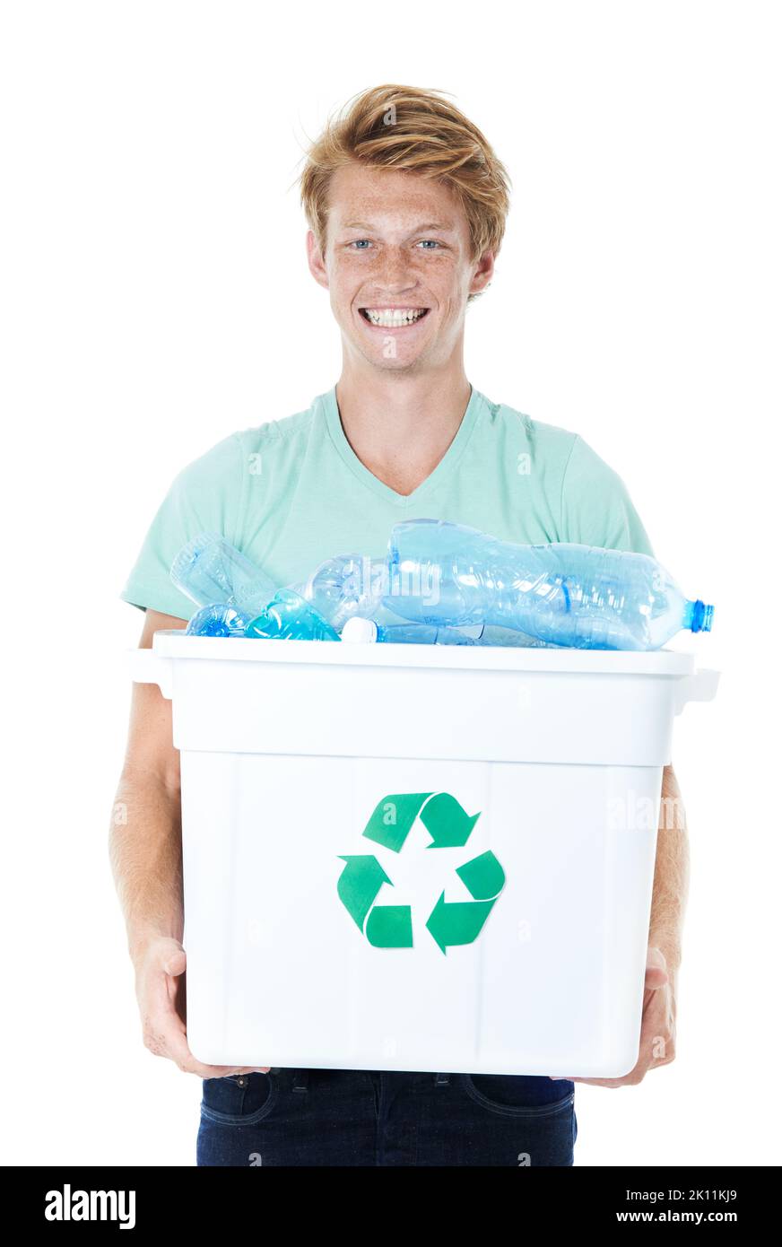 Lets reduce our waste. A happy young red-headed man holding a recycling ...