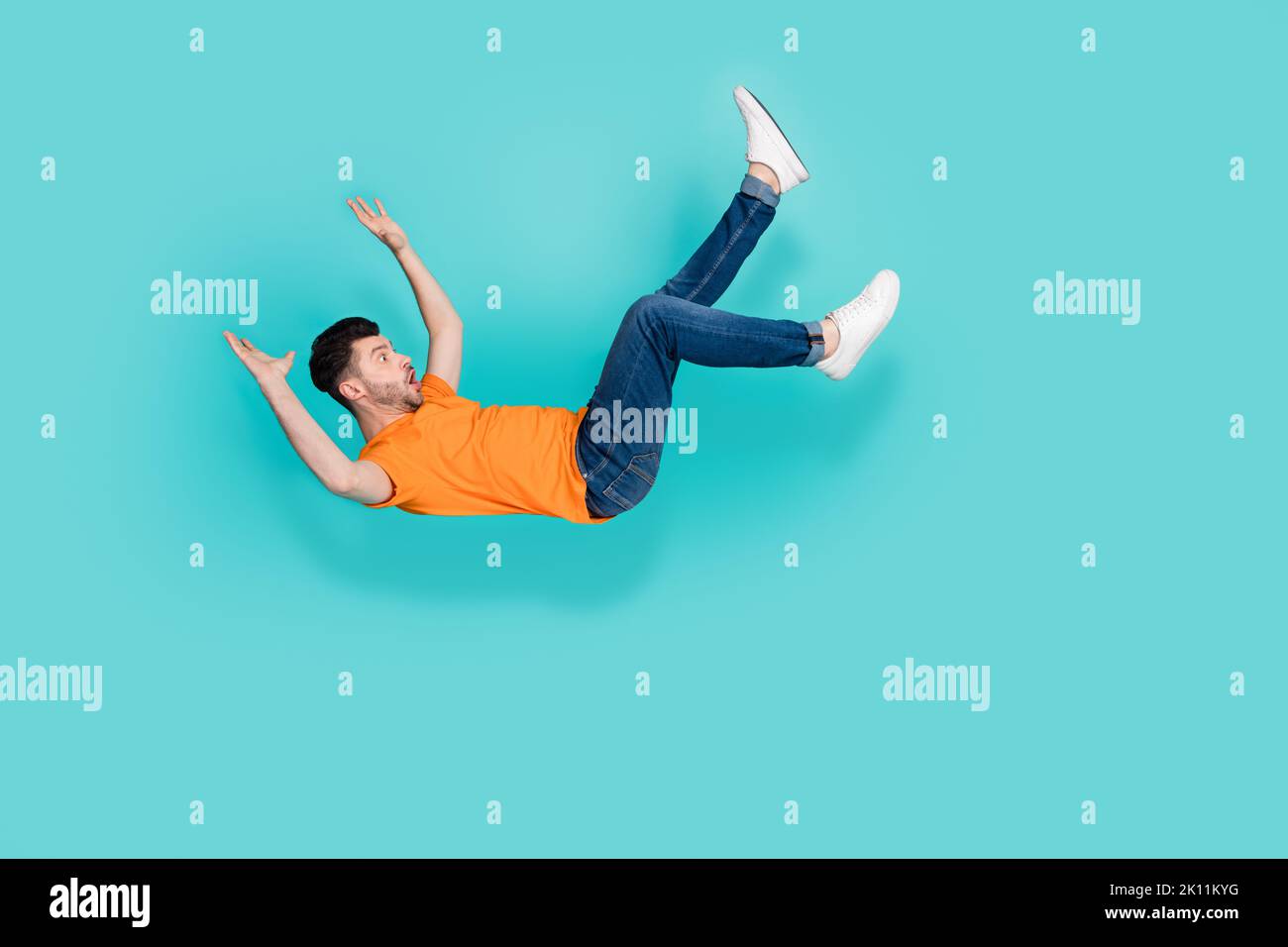 Full size photo of young handsome excited funny man slipped floor ...