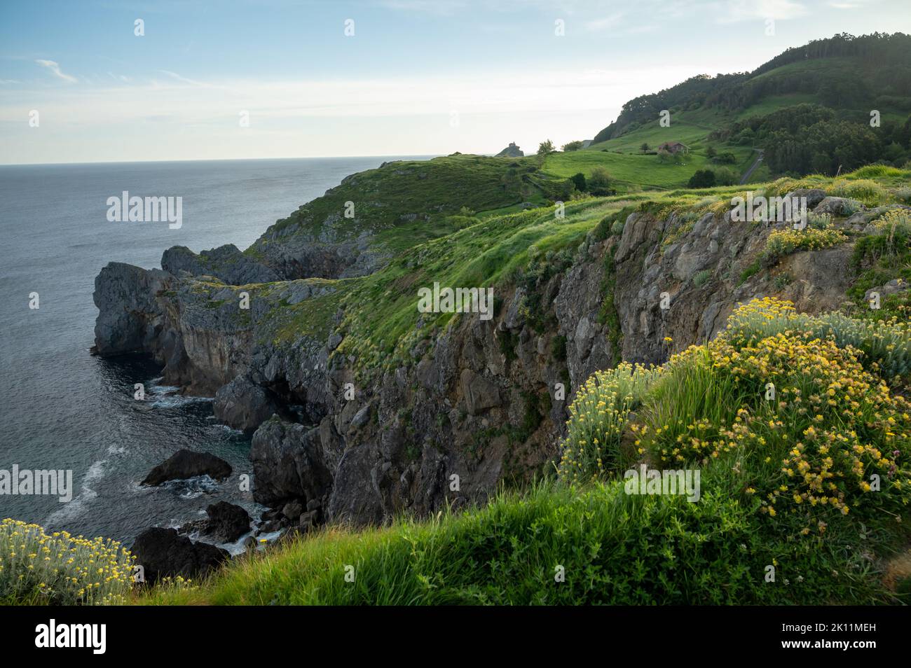 Cliffs and green pastures and meadows, Atlantic ocean bay near Bakio ...