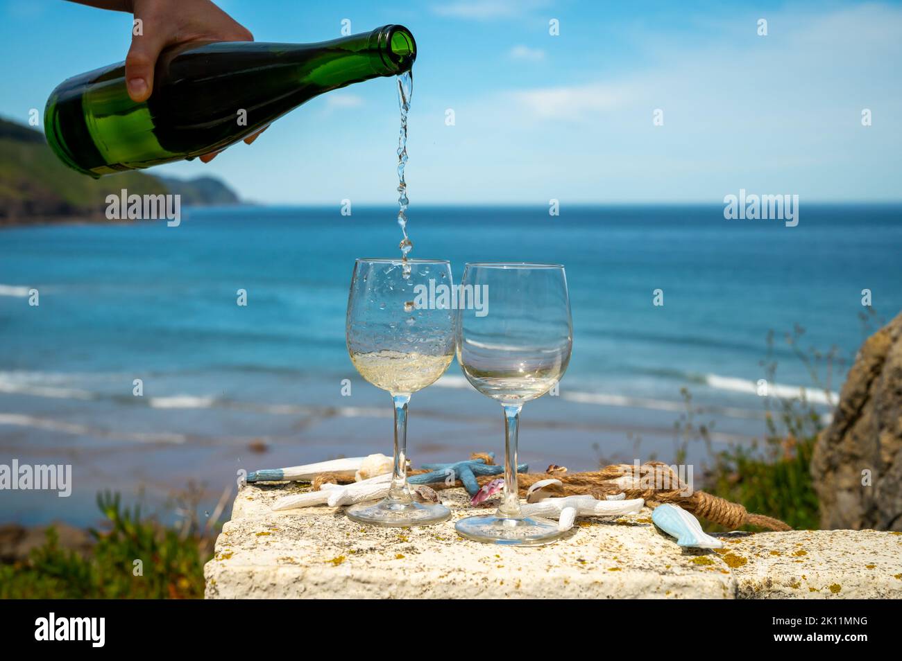 Pouring of txakoli or chacolí slightly sparkling very dry white wine ...