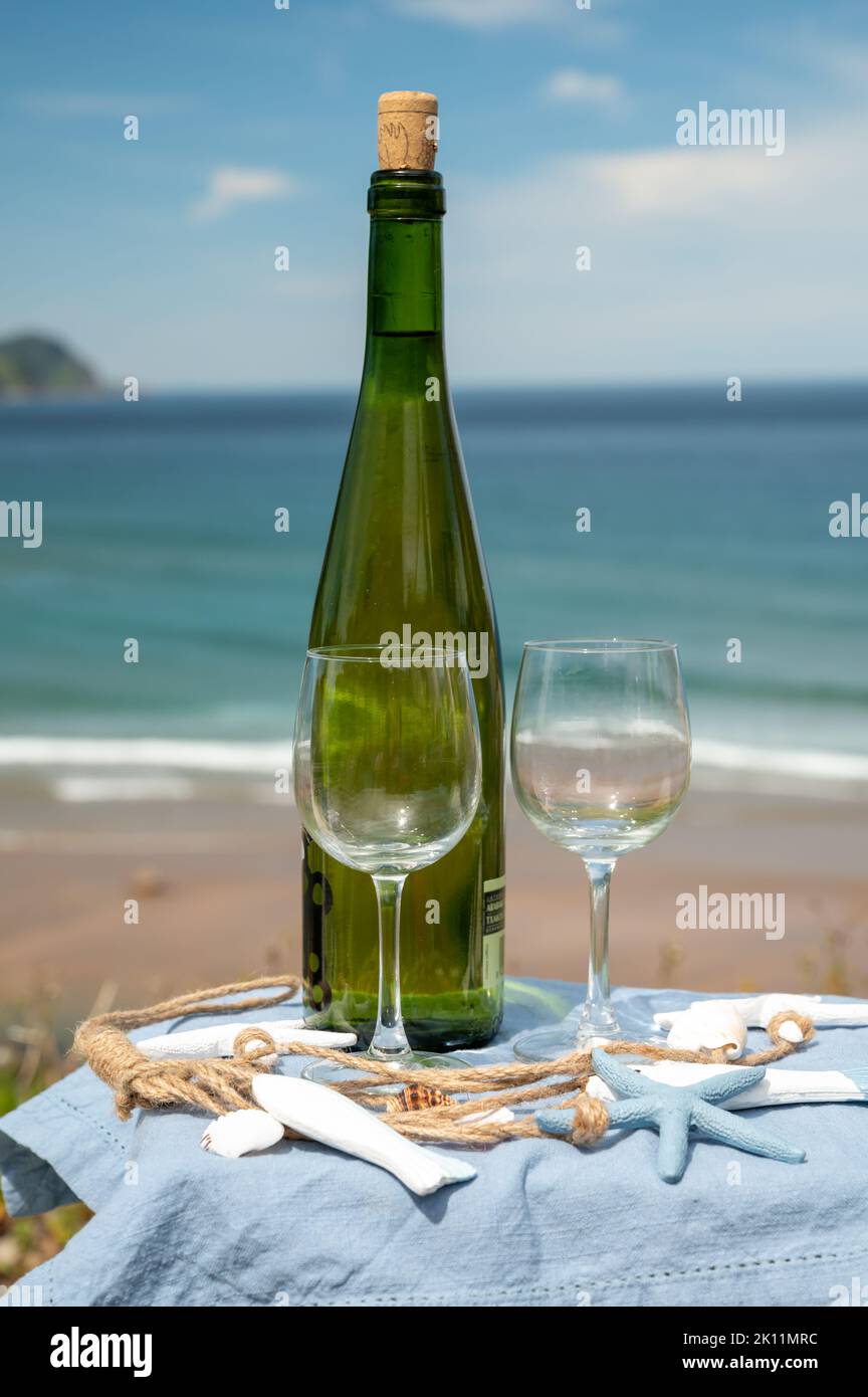 Tasting of txakoli or chacolí slightly sparkling very dry white wine ...