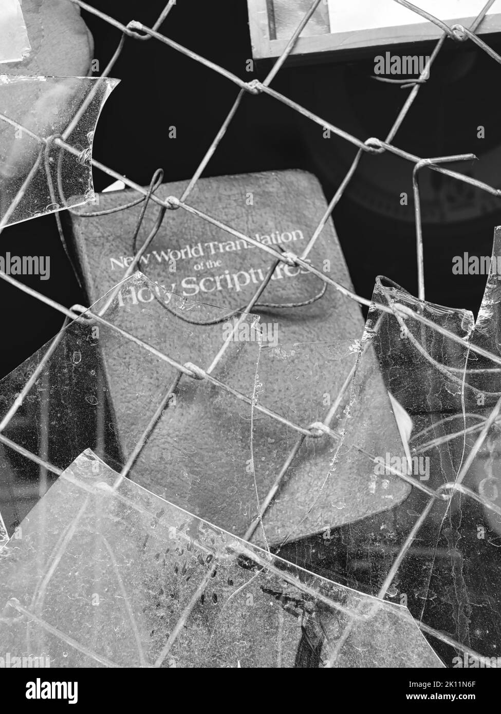 Discarded Holy bible behind fenced window Stock Photo - Alamy