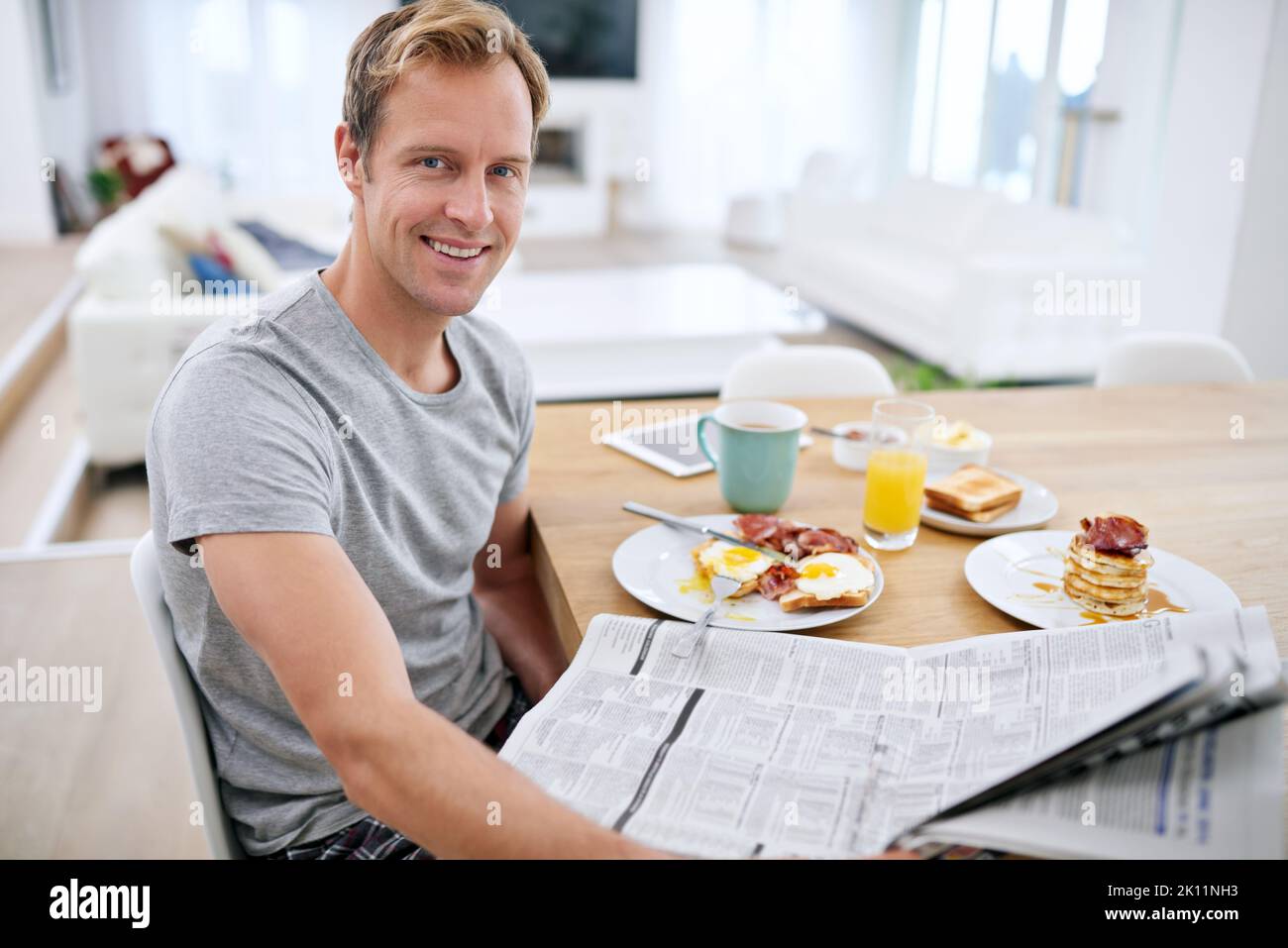 Enjoying his weekend pleasures. Portrait of a handsome man eating ...