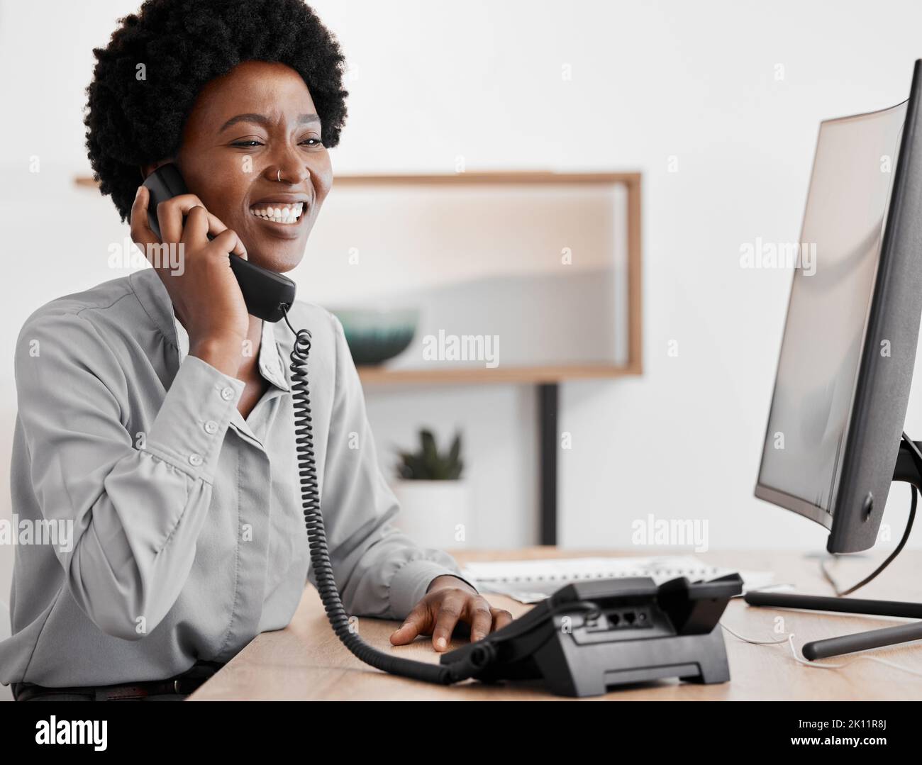 Black woman secretary on business telephone call working and in communication calling clients ...