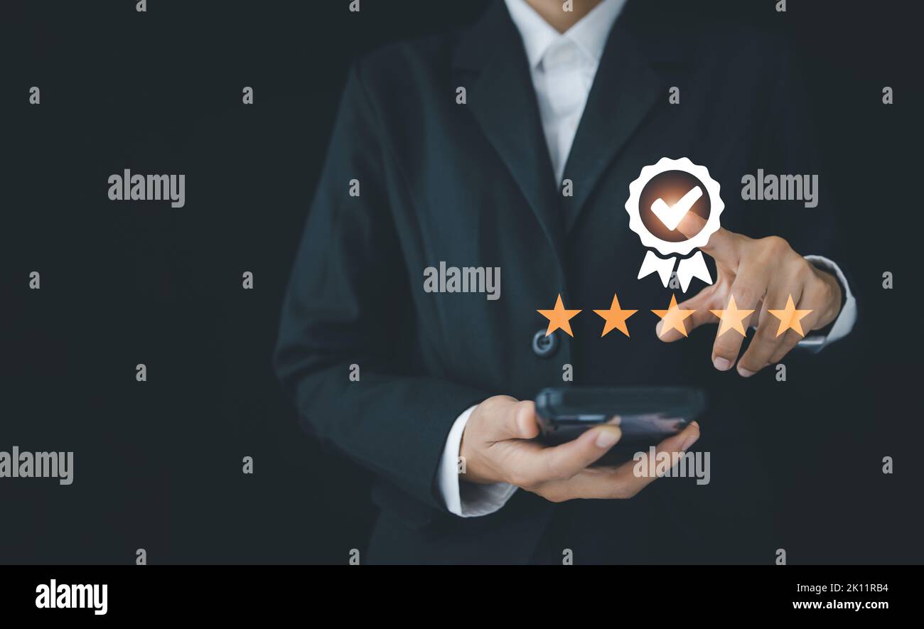 Businessman showing the best quality assurance with golden five stars ...