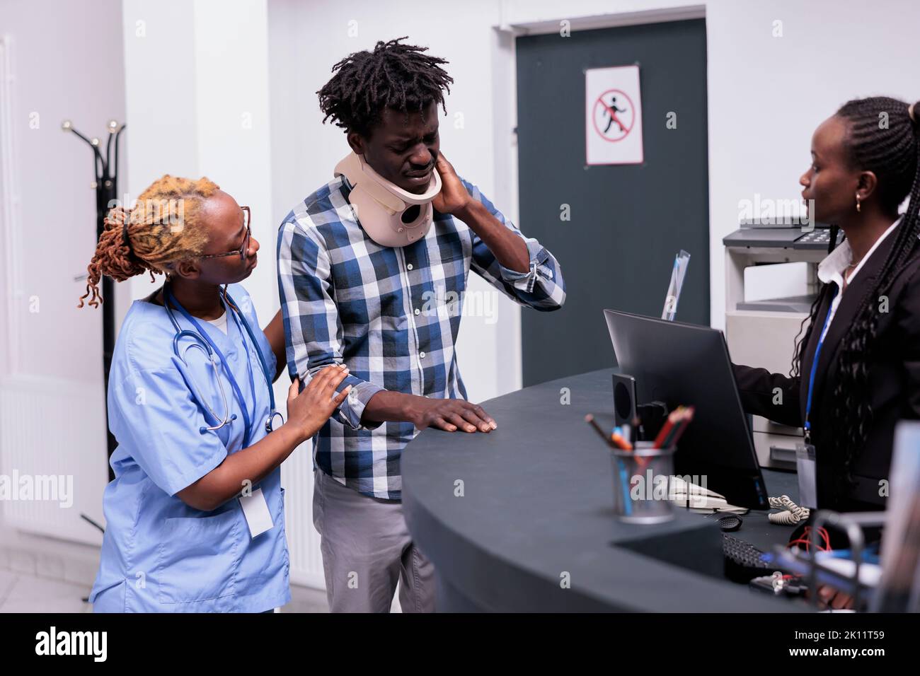 Patient with medical neck foam receiving support and help from nurse ...