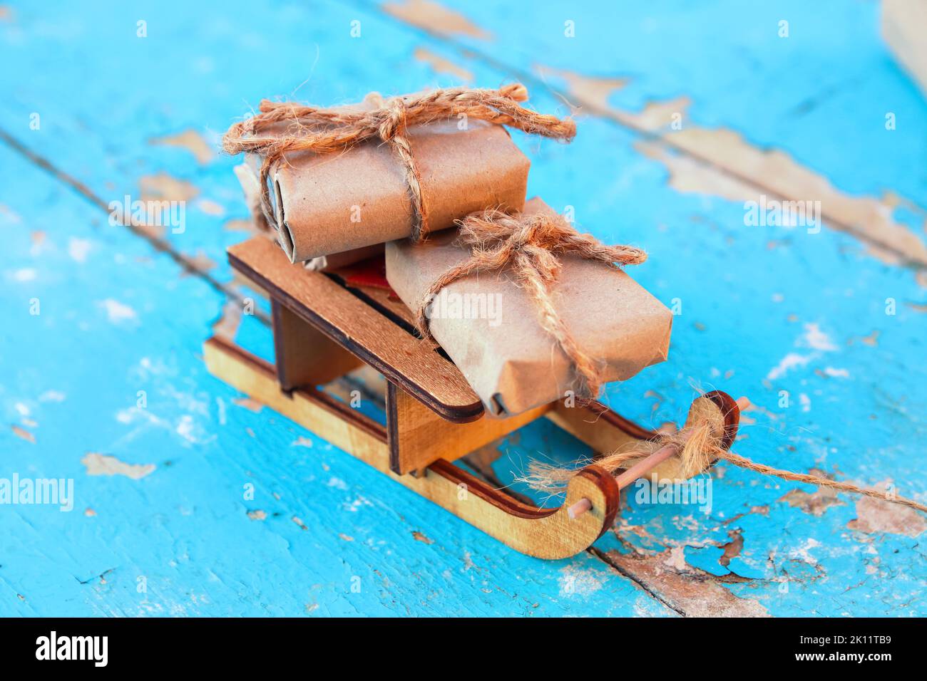 Gift boxes. Close-up wrapped craft vintage gift box lying wooden toy ...