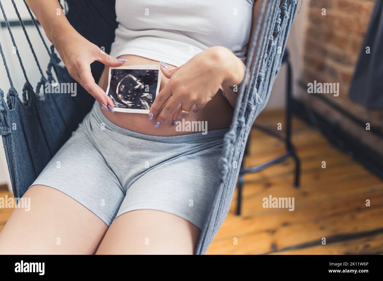 Caucasian pregnant woman holding an ultrasound scan on her baby bump. High quality photo Stock ...