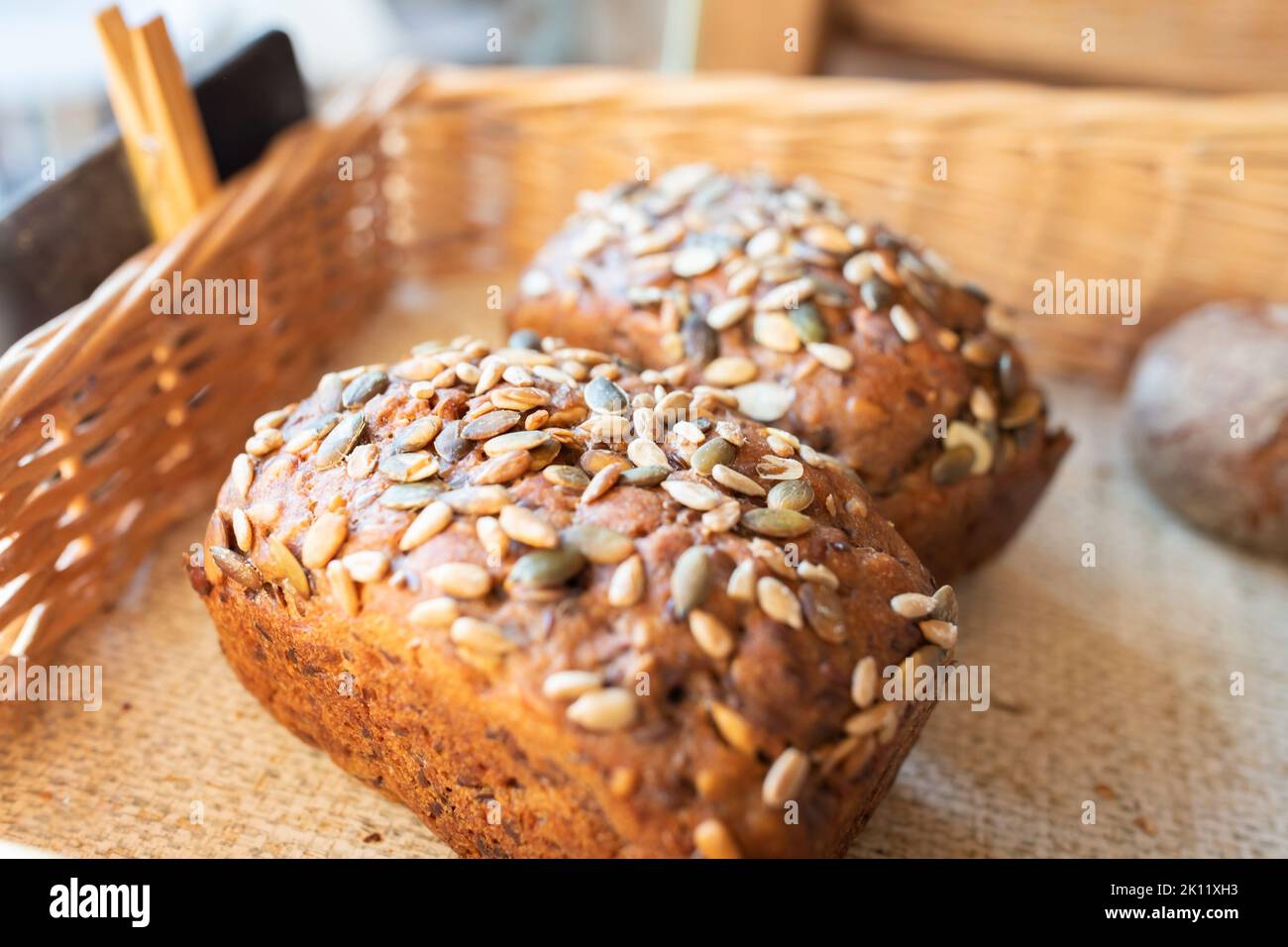Ready-made artisan bread with seeds on the counter in a small bakery ...