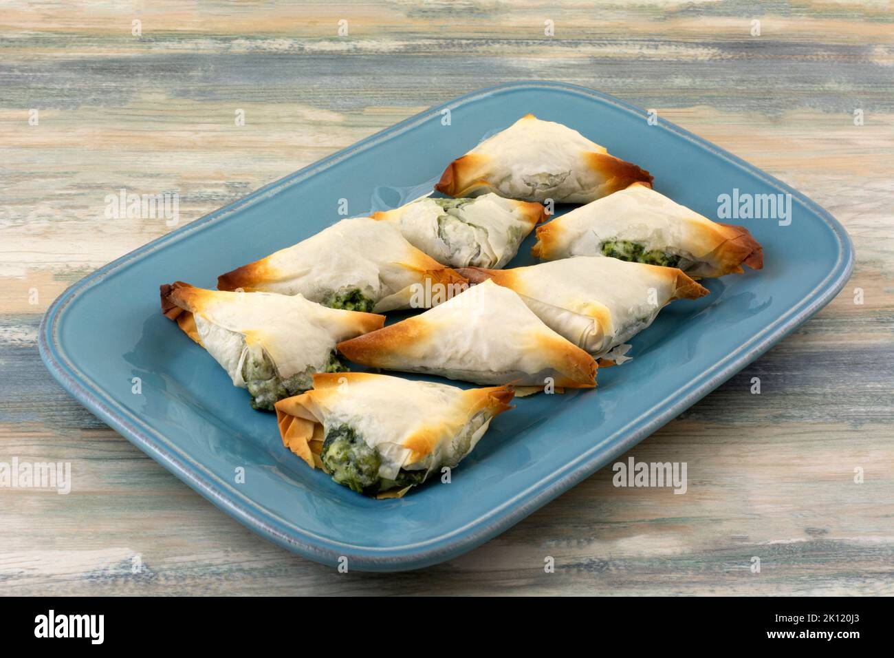 Baked feta cheese and spinach spanikopita snacks with well done edges ...