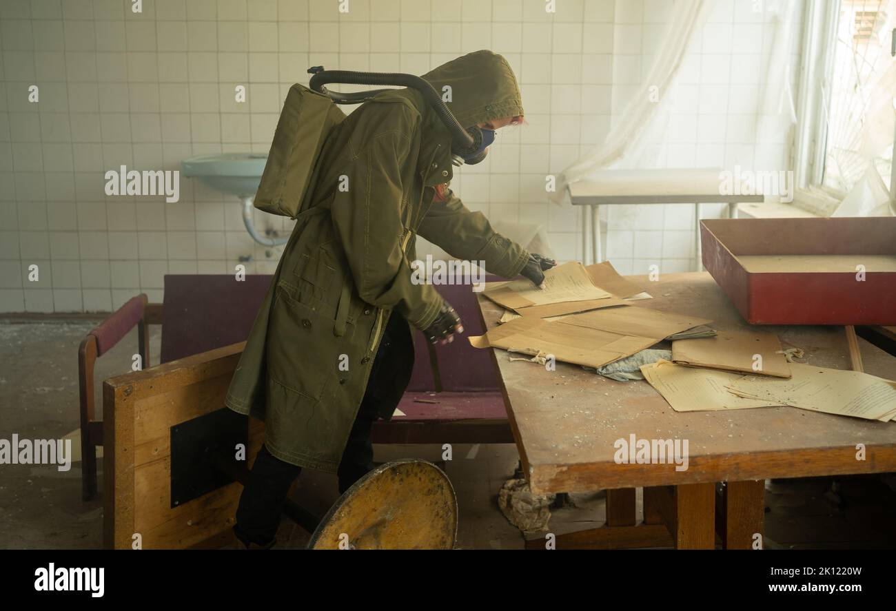 Disaster survivor in a post apocalyptic setting, she is wearing a gas ...