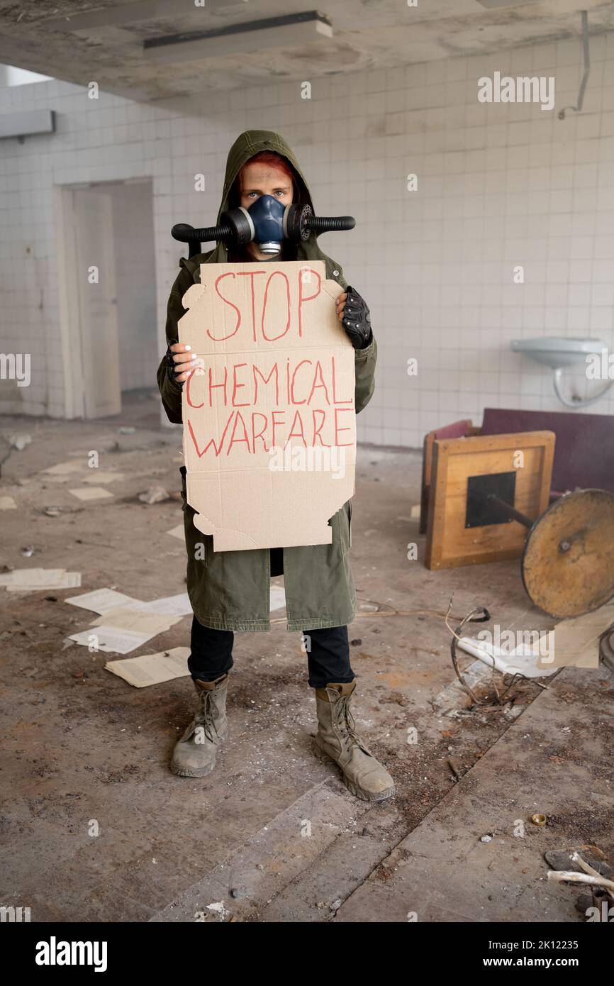 Photo of a military woman in a gas mask with banner says stop chemical ...