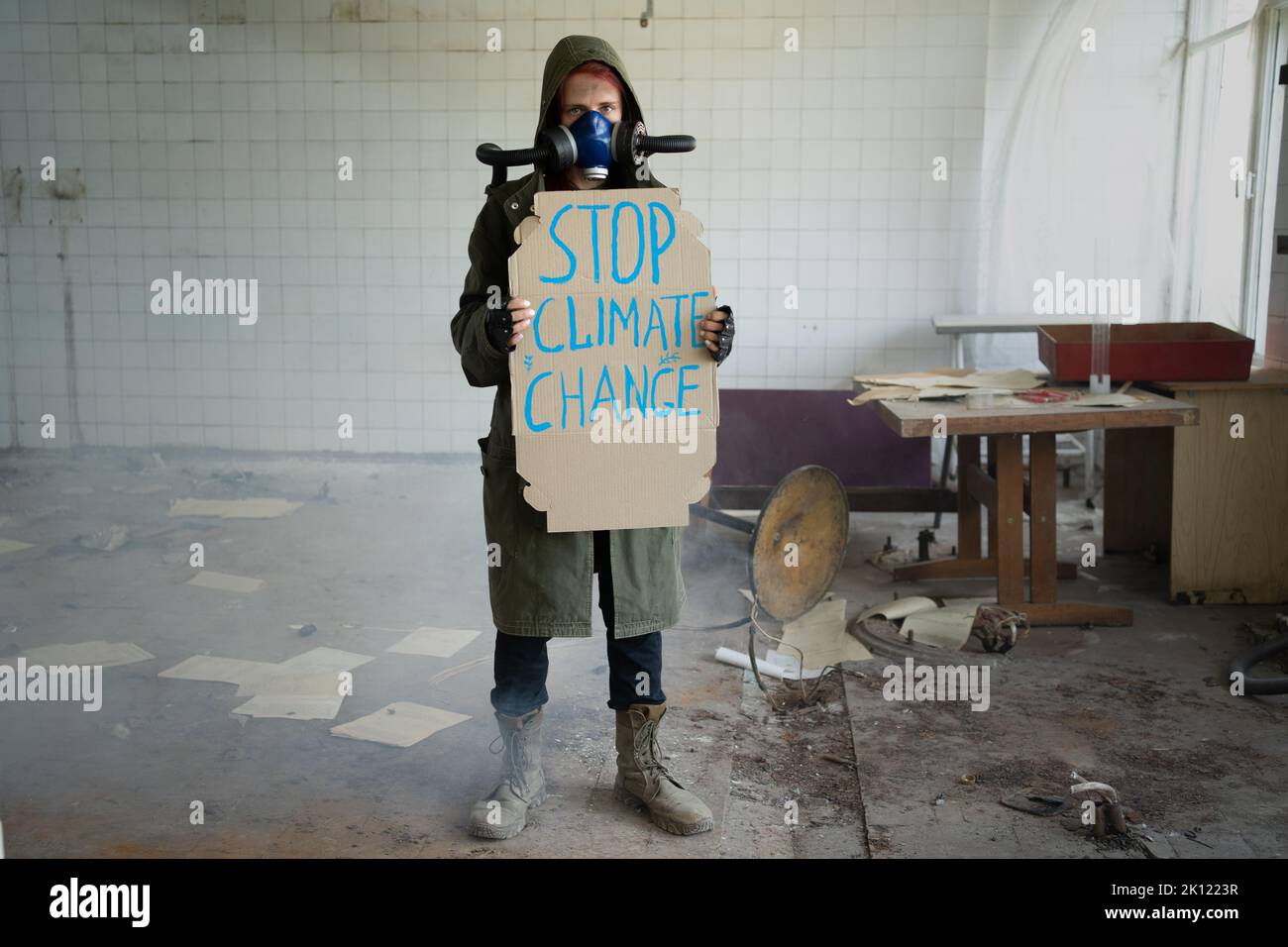 Female post-apocalyptic survivor in gas mask with banner says stop ...