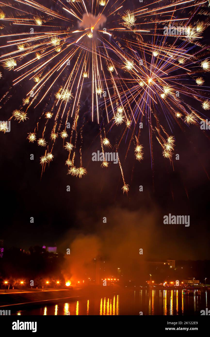 Fireworks in evening sky over river in city. Holiday concept. Close-up ...