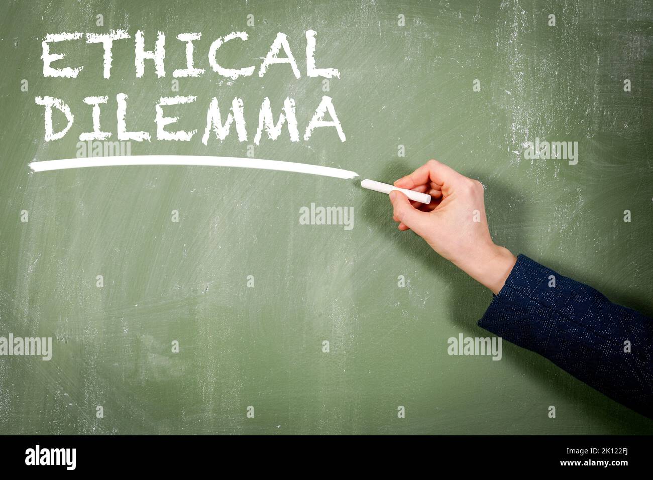 Ethical Dilemma. Woman's hand writing text on a chalkboard Stock Photo ...