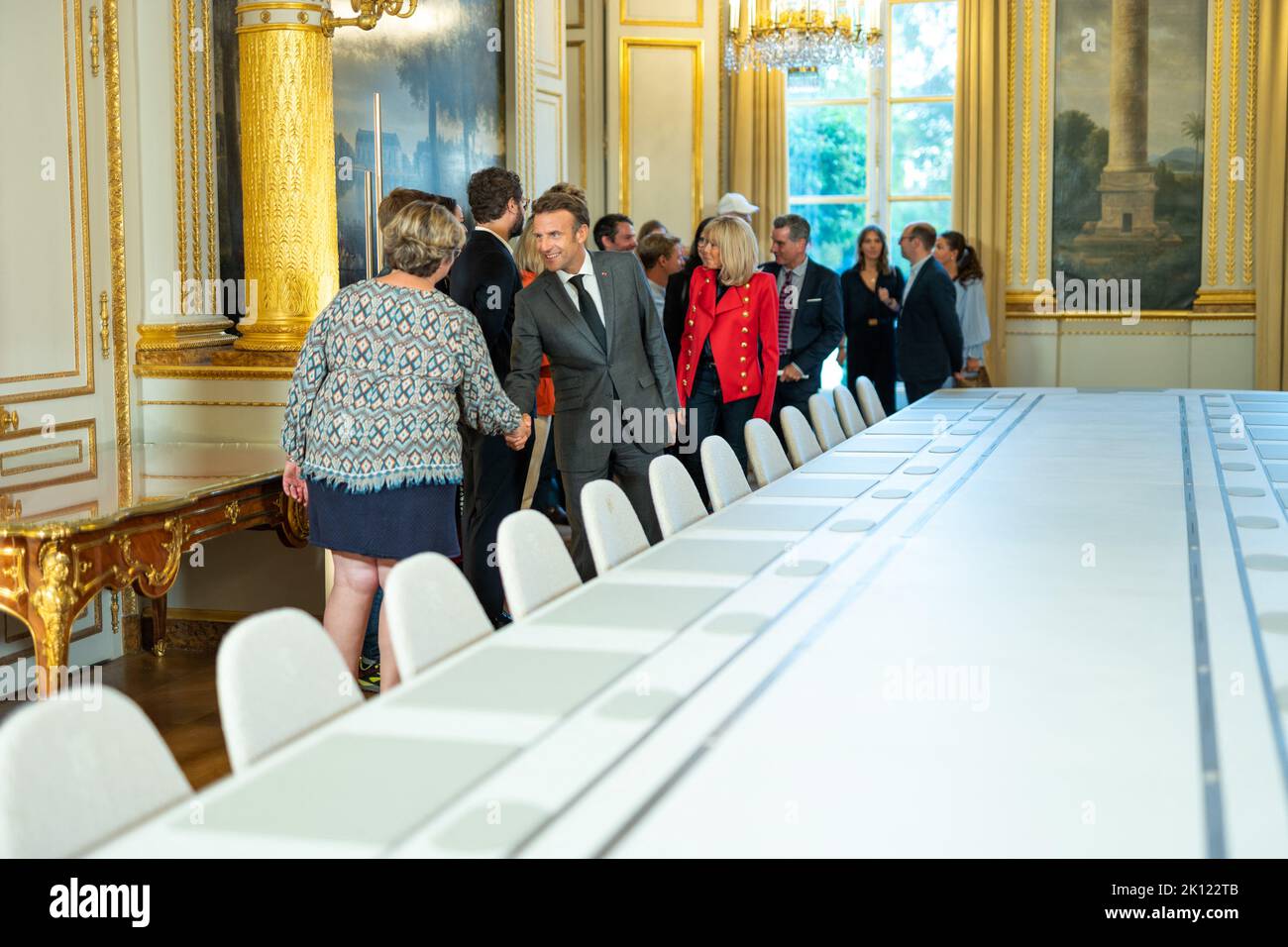 President Emmanuel Macron, flanked by his wife Brigitte Macron, meets ...