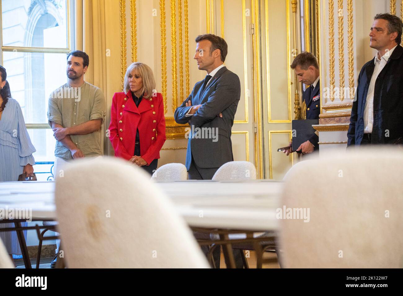 President Emmanuel Macron, flanked by his wife Brigitte Macron, meets ...
