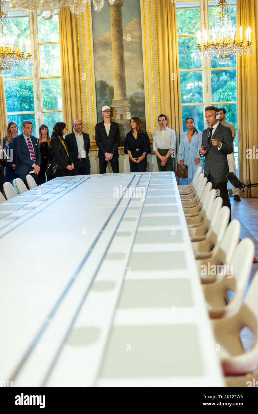 President Emmanuel Macron, flanked by his wife Brigitte Macron, meets ...