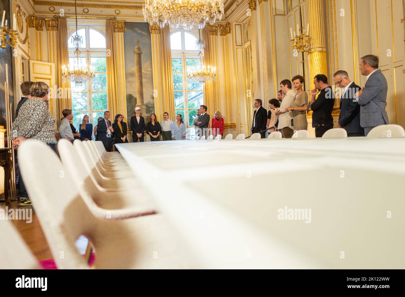 President Emmanuel Macron, flanked by his wife Brigitte Macron, meets ...