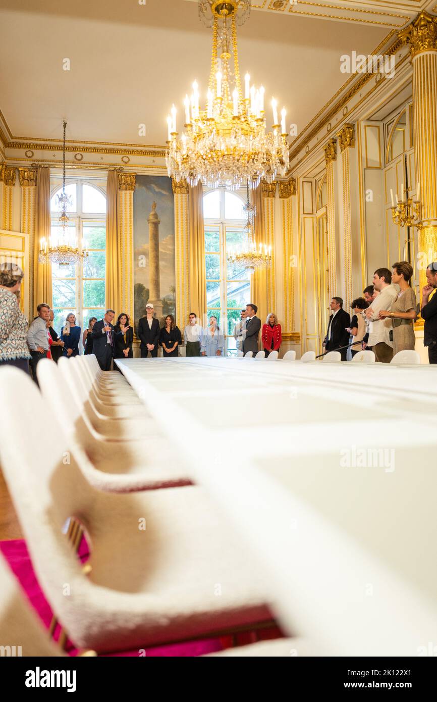 President Emmanuel Macron, flanked by his wife Brigitte Macron, meets ...