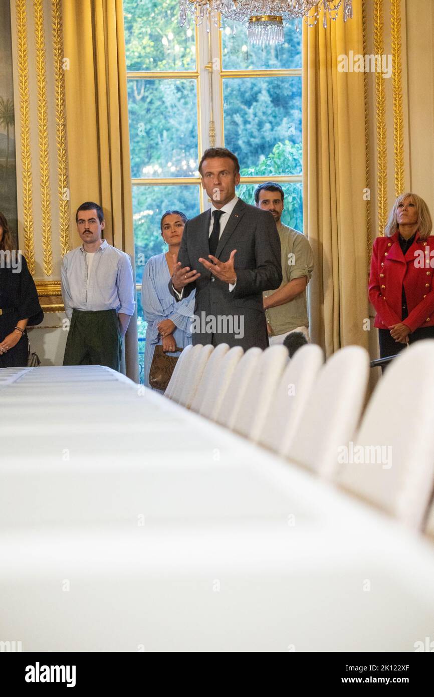 President Emmanuel Macron, flanked by his wife Brigitte Macron, meets ...