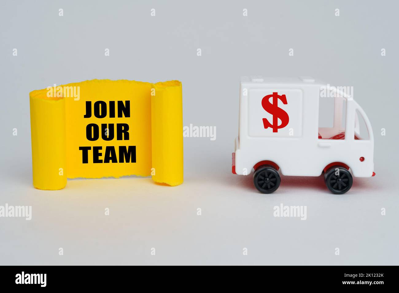 Business concept. On a white surface, a typewriter and a yellow paper ...