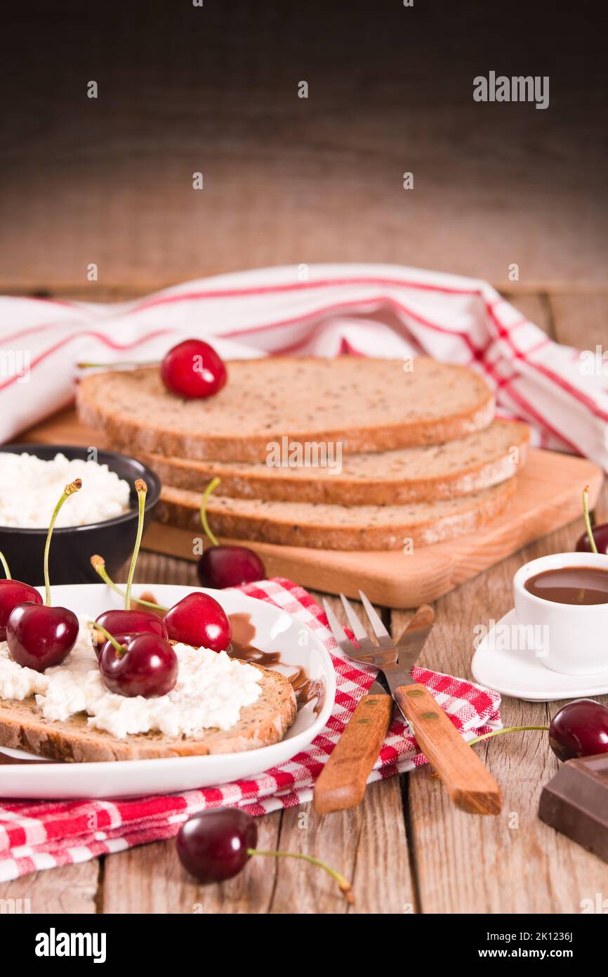 Rye bread with cottage cheese and cherries Stock Photo - Alamy