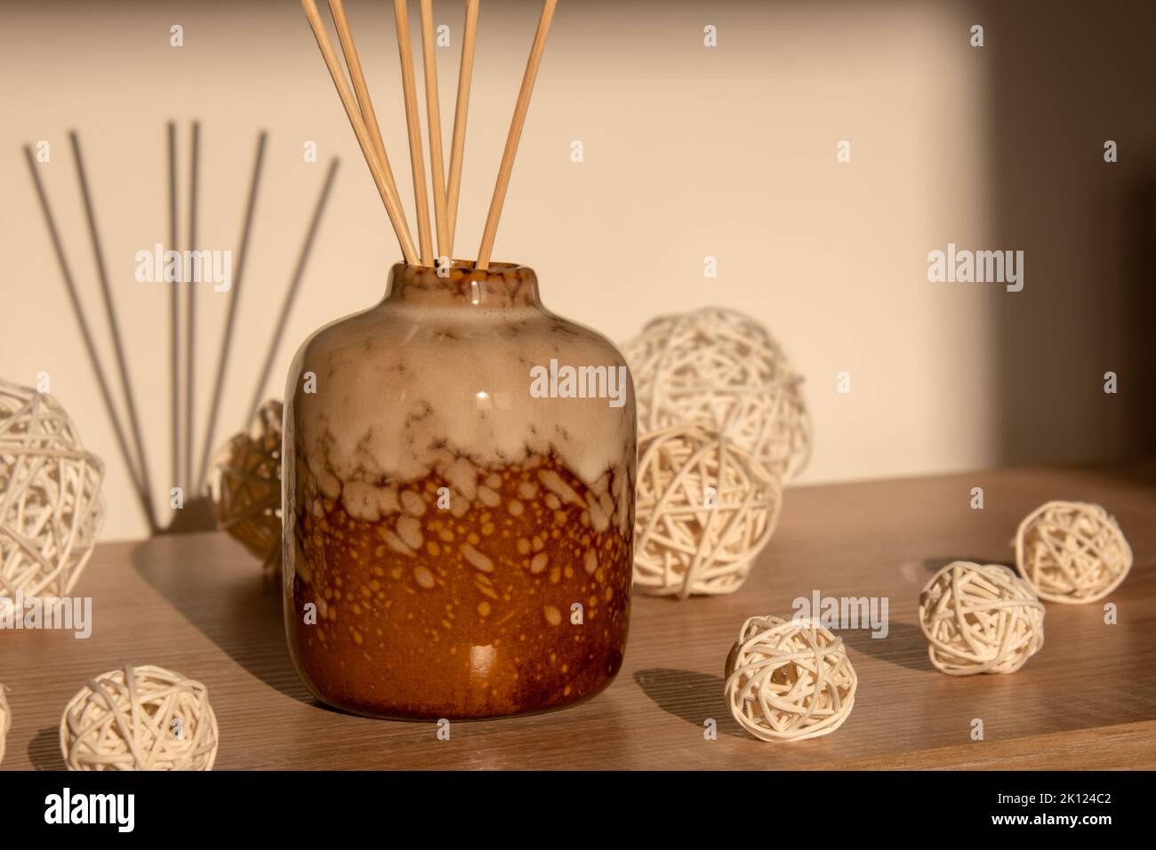 Cozy home decorations aroma reed diffuser in the living room. Home comfort concept. Bottle ...