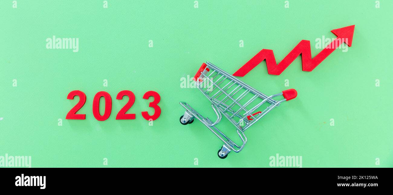 2023 year, Groceries price up, food rising cost. Shopping cart and red ...