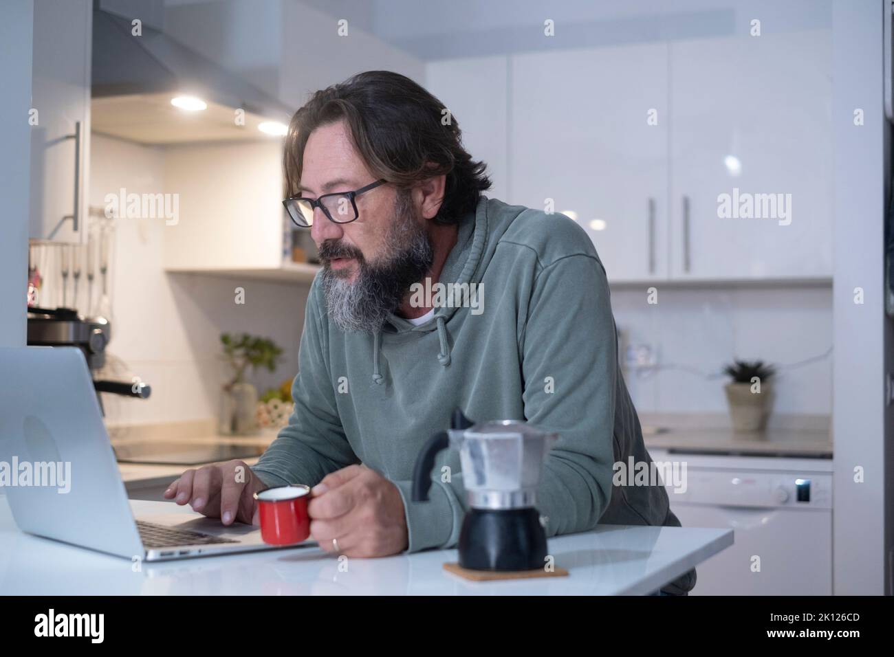 One man at home having breakfast before work drinking italian coffee ...