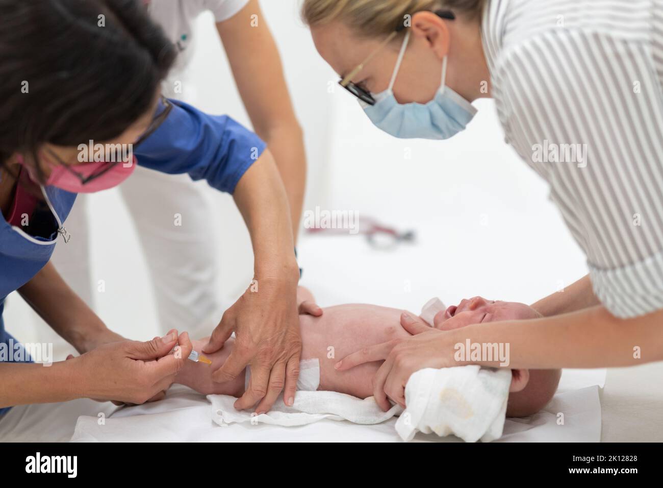 Baby beeing vaccinated by pediatrician in presence of his mother ...