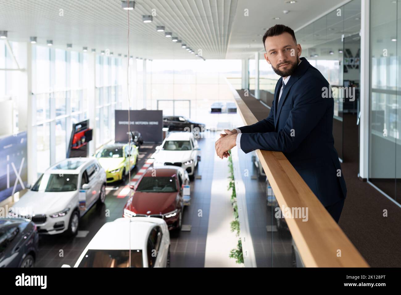 owner of a car dealership on the background of new cars, Concept car ...
