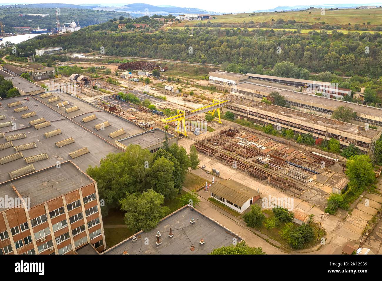 aerial view from drone of factory with warehouse of steel elements and ...