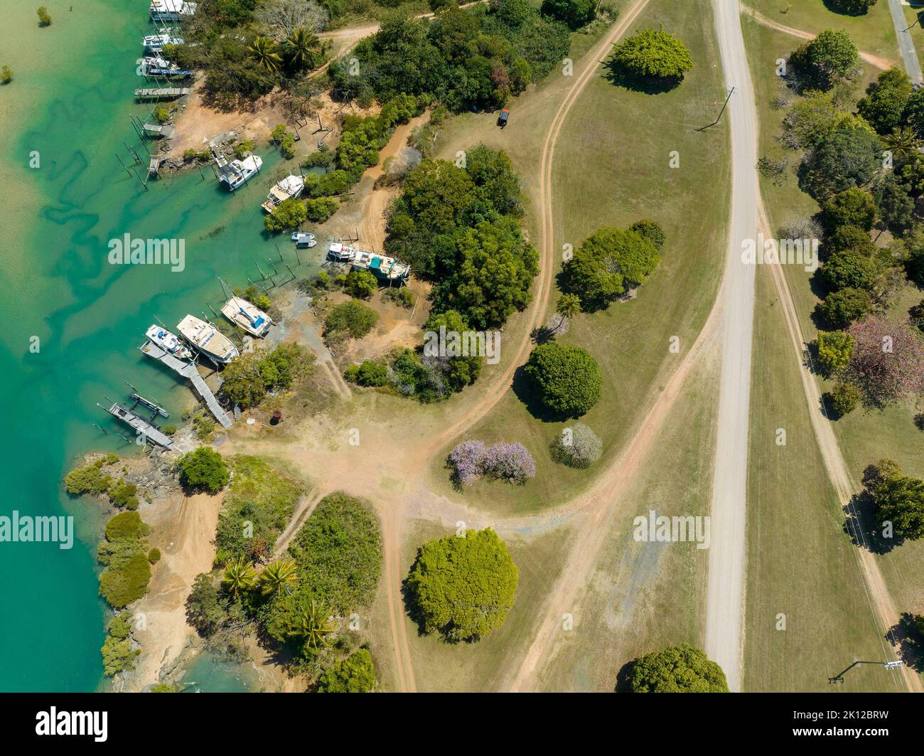 Boats moored on the banks of Grasstree Beach on the incoming tide ...