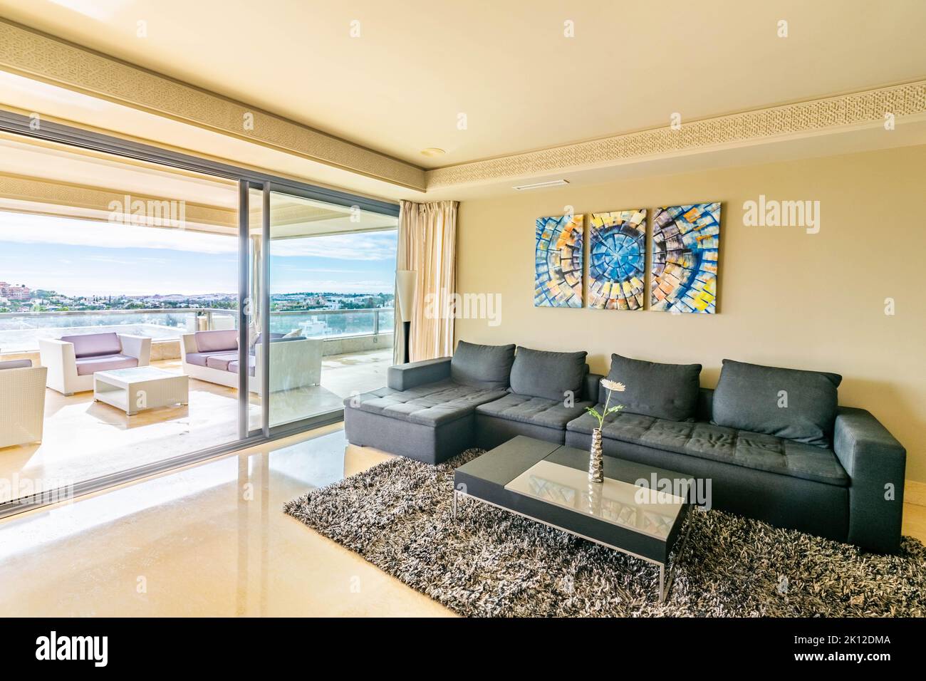 a view of a comfy sofa next to a balcony with Mediterranean views of ...