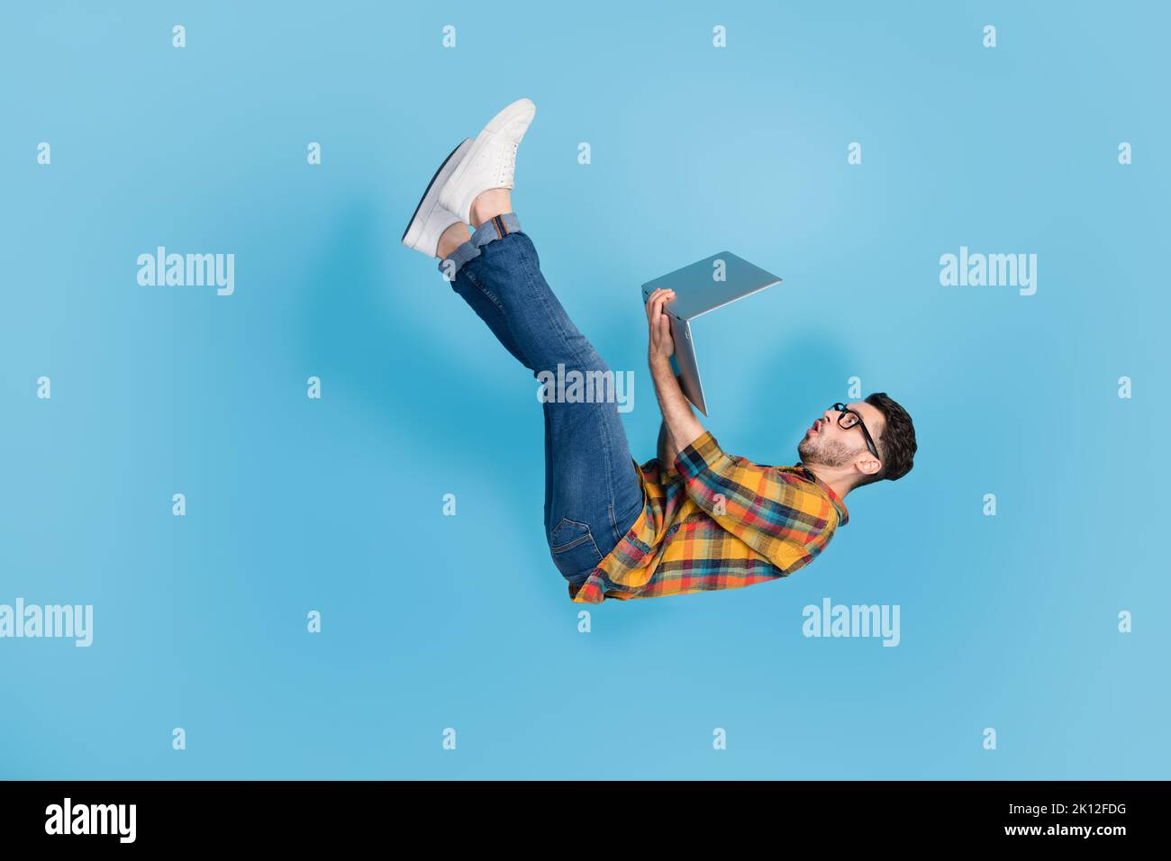 Full length profile portrait of impressed falling man use netbook ...