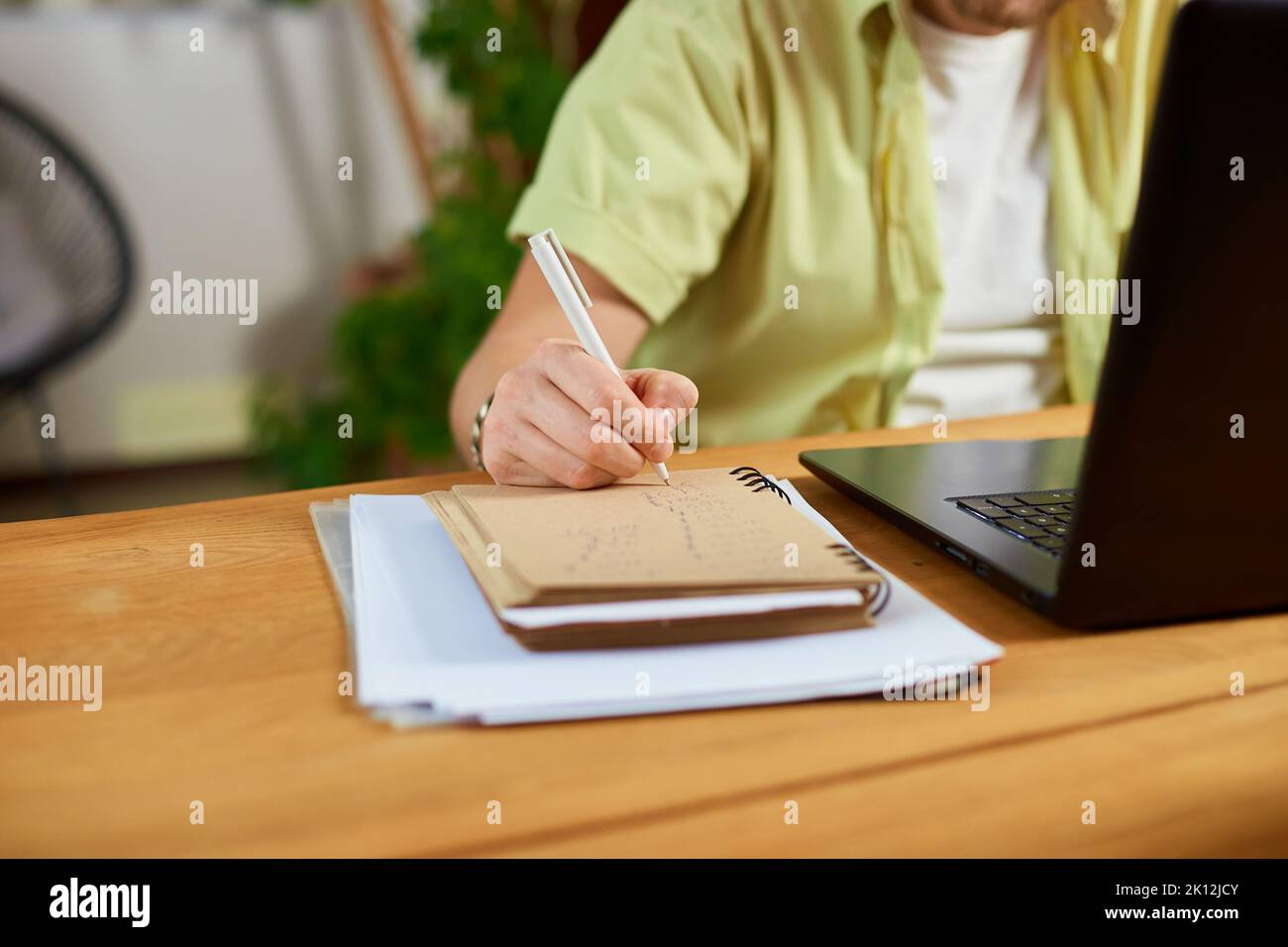 Internet for learning and job search. Man hand making notes in notepad ...