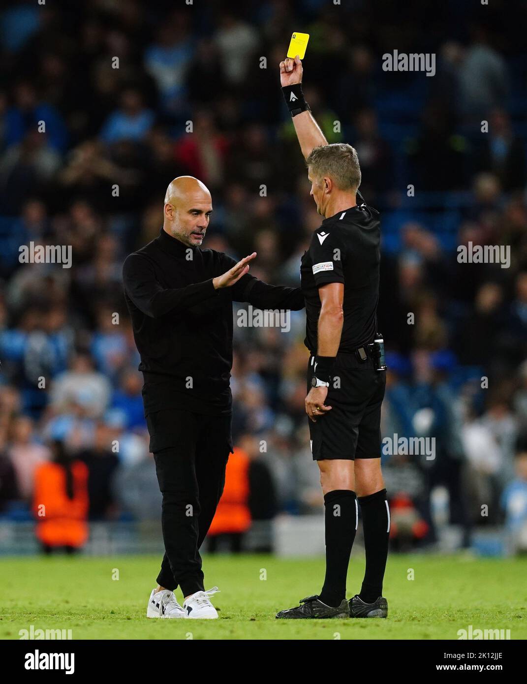 Manchester City manager Pep Guardiola is shown a yellow card by referee ...