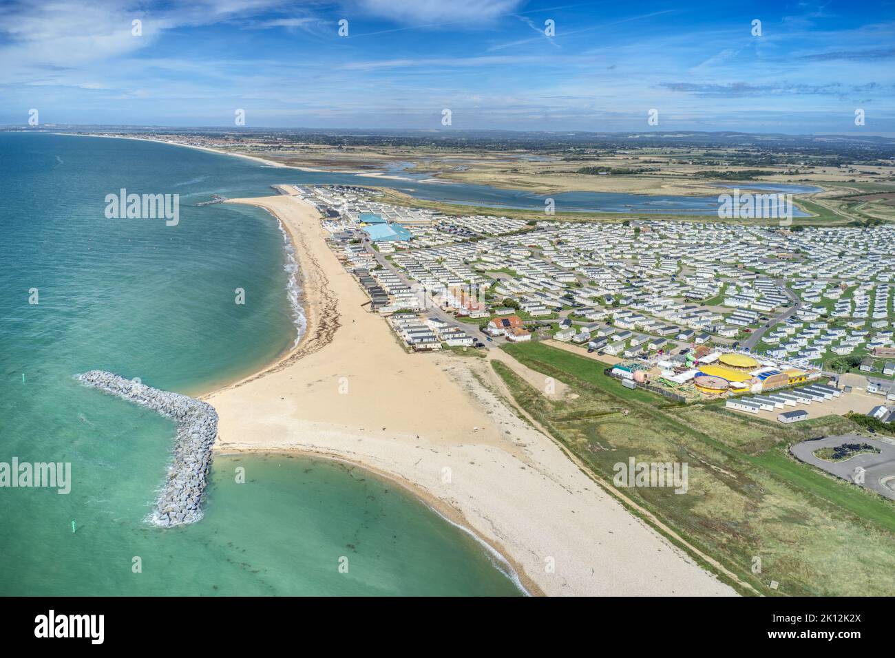 West Sands at Selsey in West Sussex with a large holiday caravans park ...