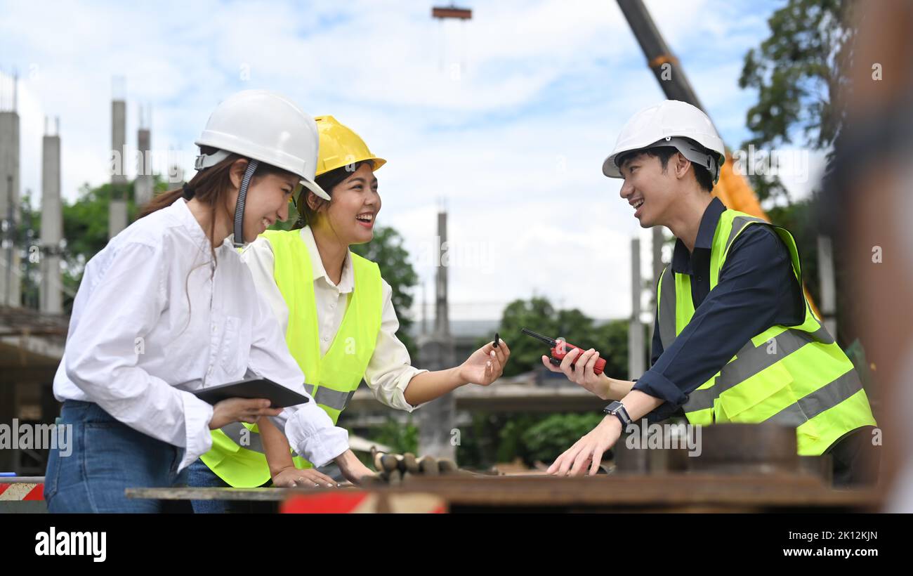 Engineer team in safety helmet and reflective jackets are planning ...